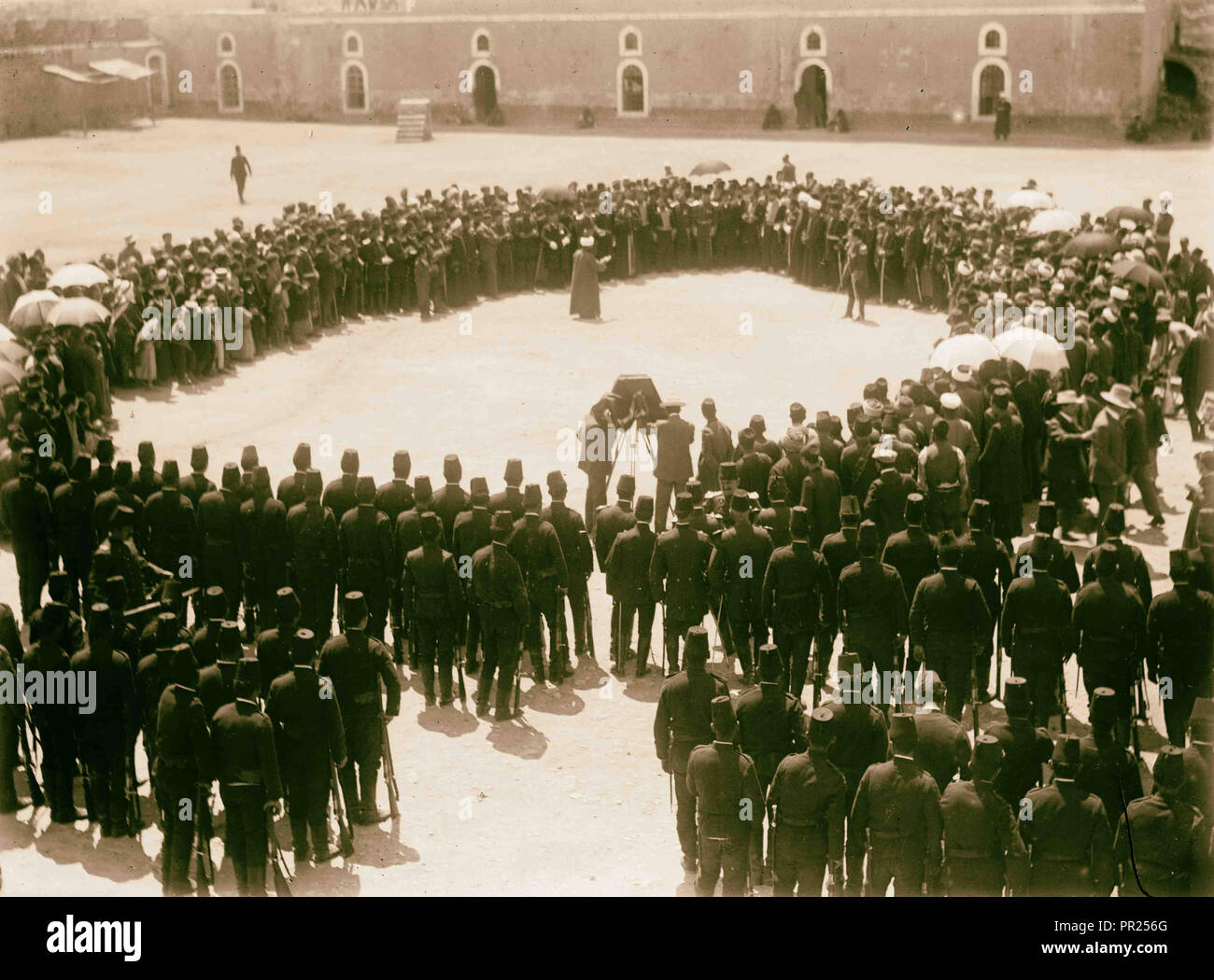 Turkish military WWI. Man being photographed in a circle of people with ...
