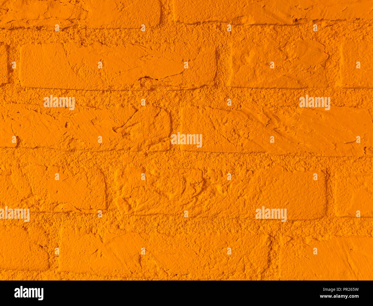 Modern vibrant orange stone brick wall with big bricks close up ...