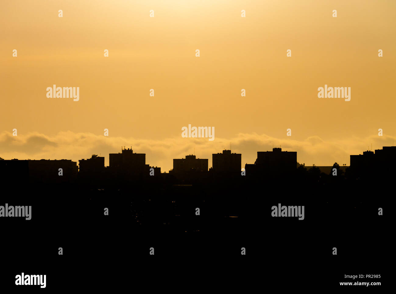 Various silhouettes of building tops at sunset Stock Photo - Alamy