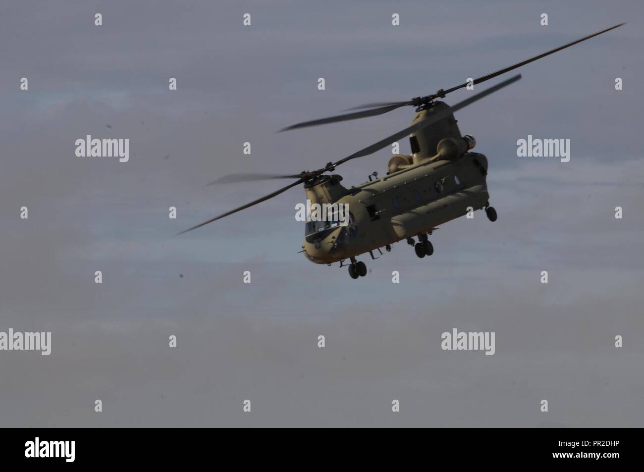 CH-47 Chinook makes its final approach to pick up equipment during a sling load operation as ...