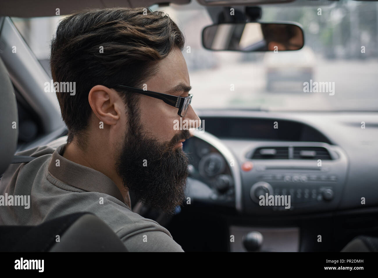 Serious man driving carefully the car. Drive safely. Driver paying ...