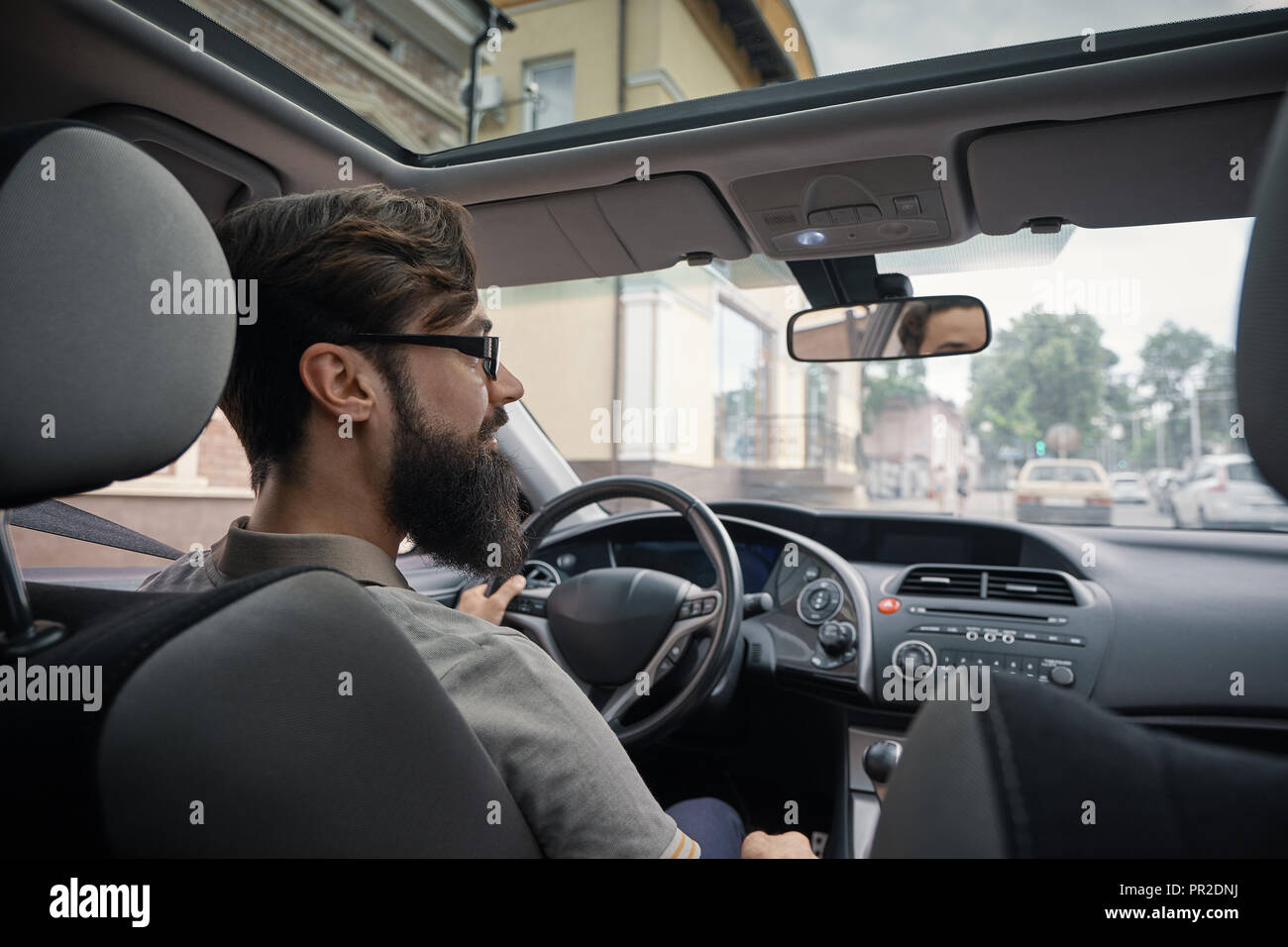 Serious man driving carefully the car. Drive safely. Driver paying ...