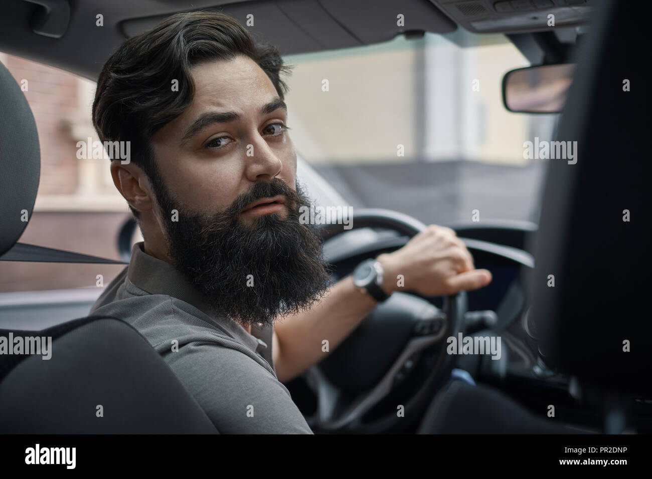 Serious man driving carefully the car. Drive safely. Driver paying ...