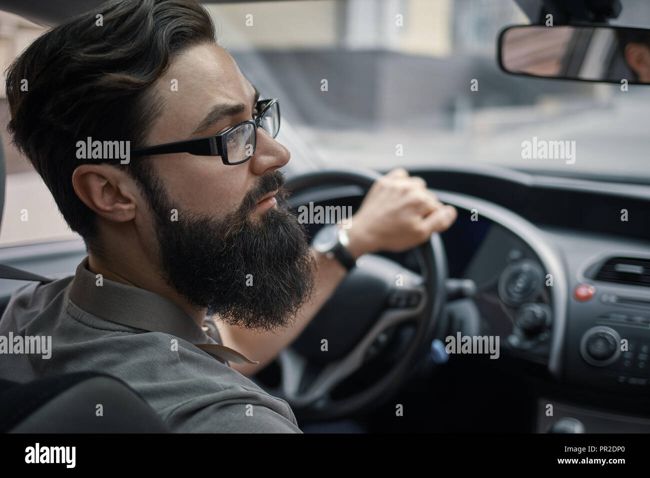 Serious man driving carefully the car. Drive safely. Driver paying ...
