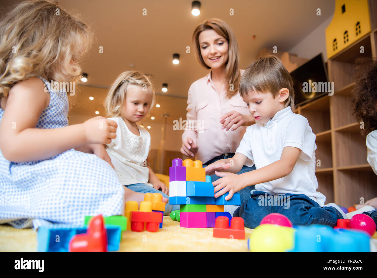 Woman children playing constructor hi-res stock photography and images ...