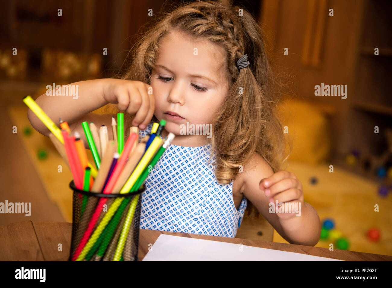 adorable kid choosing colored felt tip pen for drawing in kindergarten ...