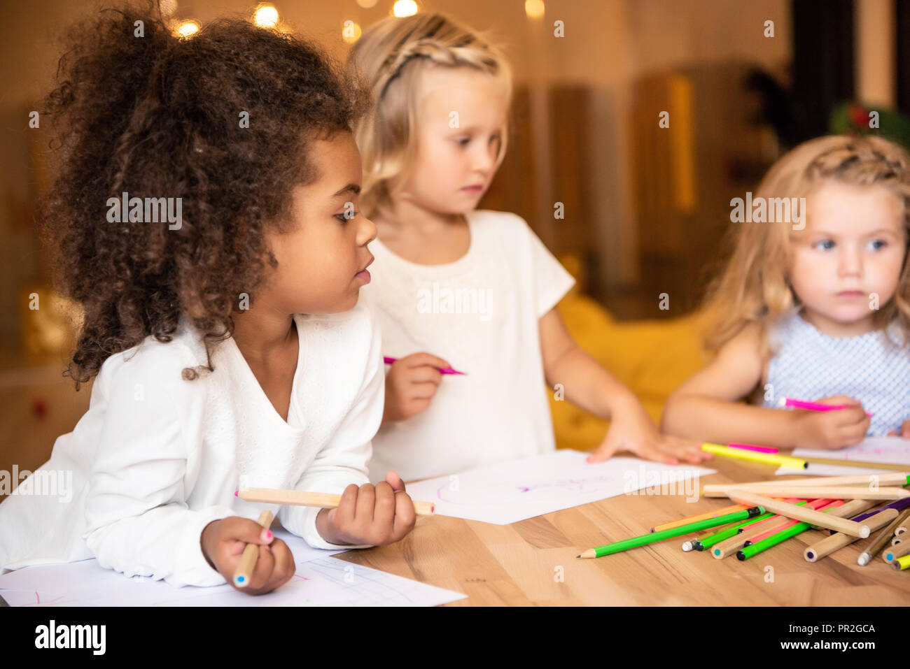 multicultural kids drawing together in kindergarten Stock Photo - Alamy