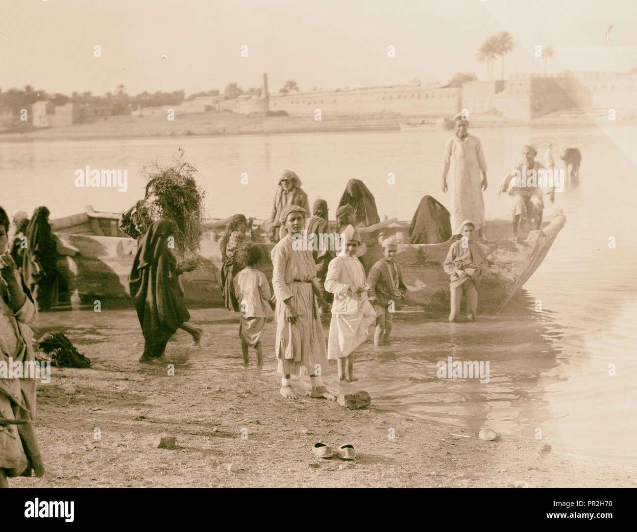 Iraq, river, people at boats with town on other side. 1932, Iraq Stock ...