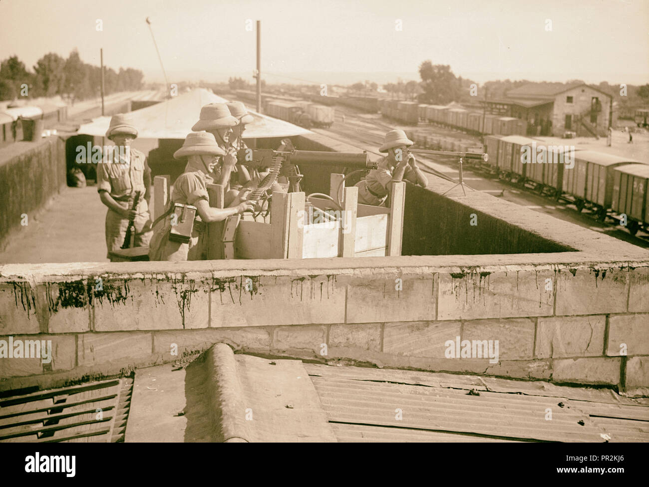 British troops with machine gun on Lydda Junction Station roof, Oct. 31 ...