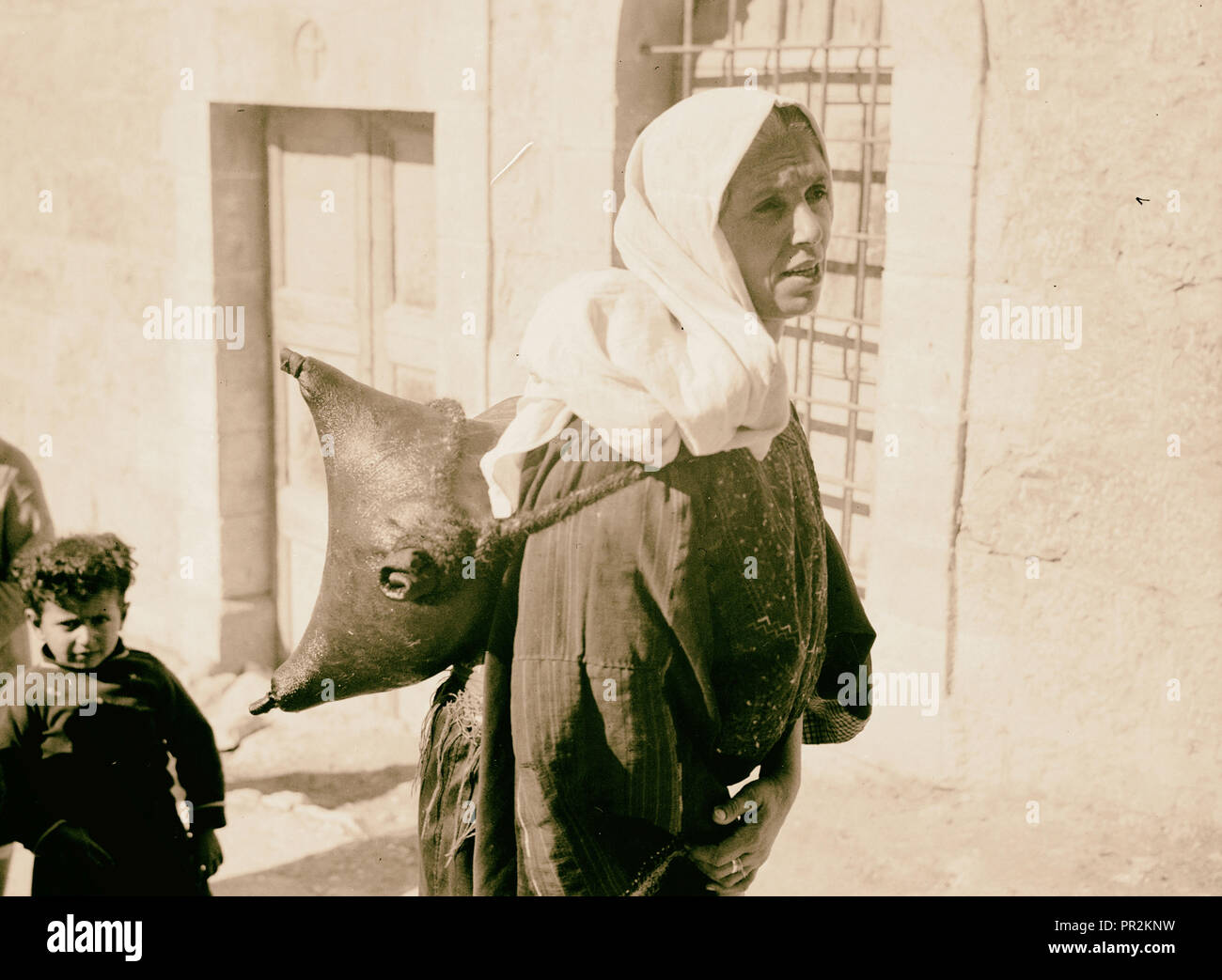 Bethlehem woman carrying water in a goatskin. 1934, West Bank ...