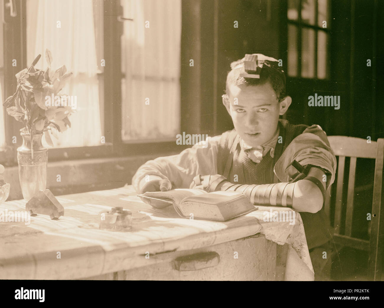 Askenazim, Ashkenazi Jewish youth studying his Torah with phylacteries ...