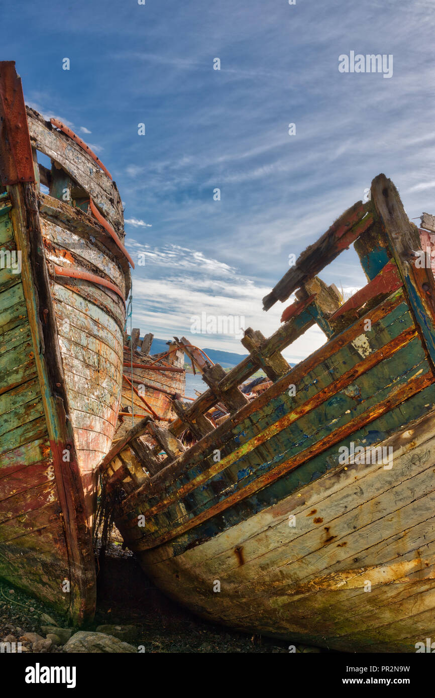Abstract vertical photo of two green and red wooden boats wrecked and ...