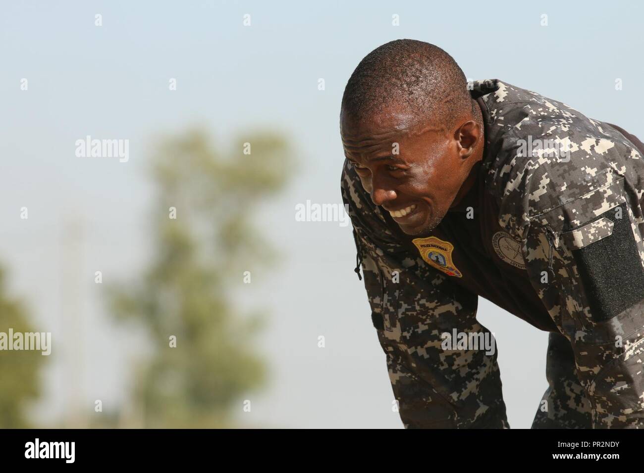A Haitian competitor grimaces after sprinting through the finish line ...