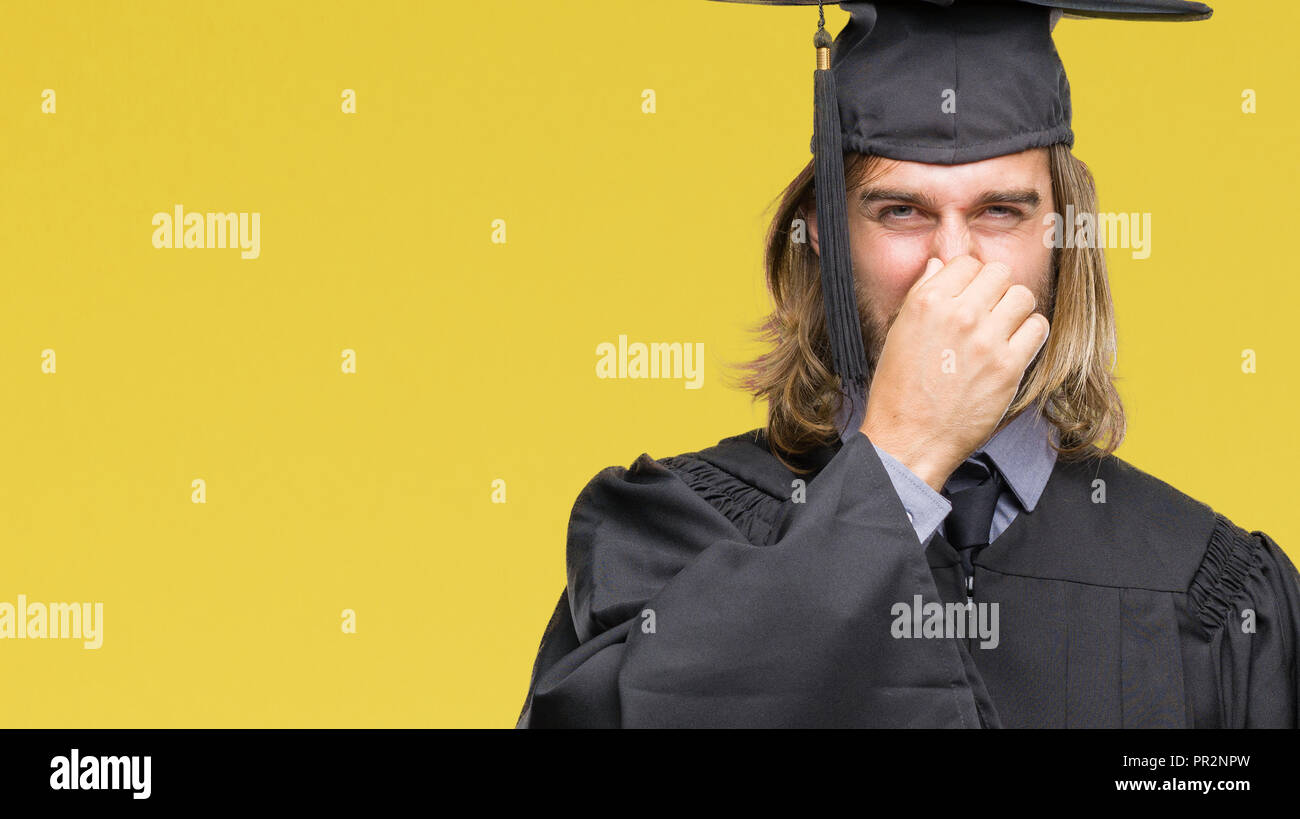 Young handsome graduated man with long hair over isolated background ...
