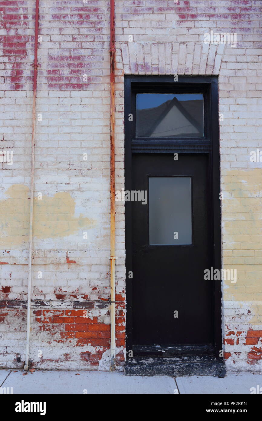A door without handle, part of a colorful brick wall. (Toronto, CA ...
