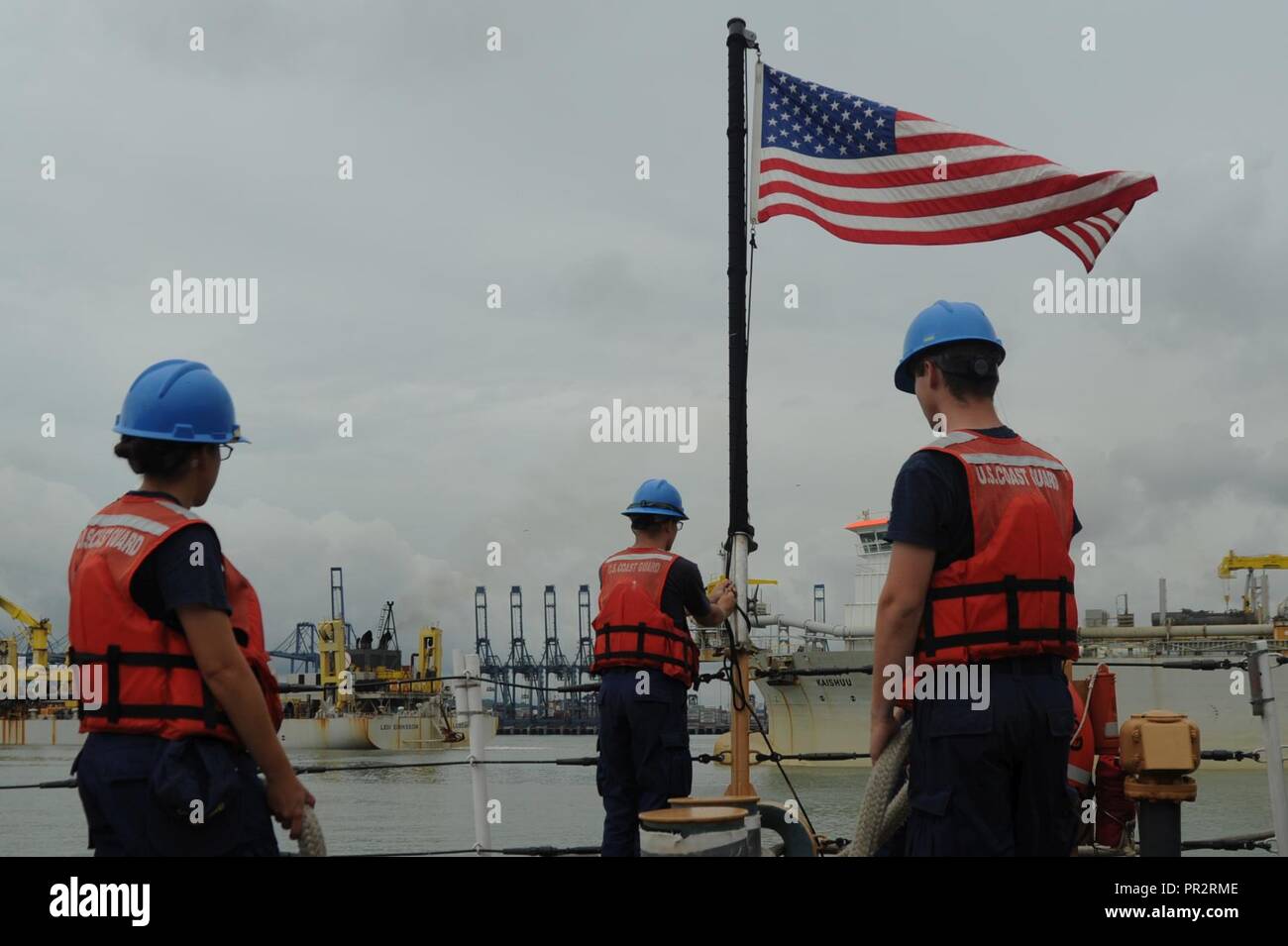 Coast Guard deck crew members of the USCGC Tampa prepare to get ...