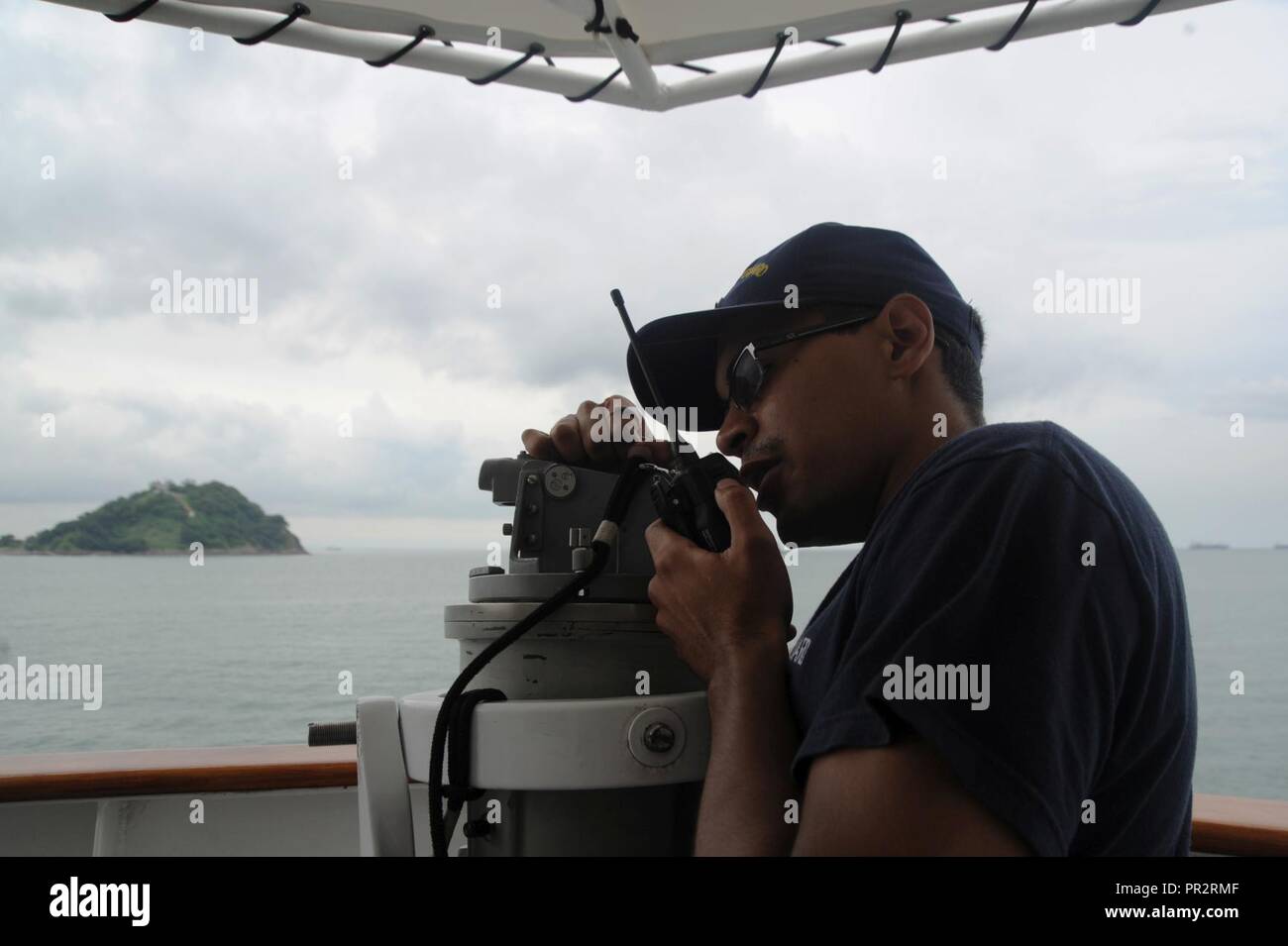 Coast Guard Petty Officer 3rd Class Jeffrey Reyes mans the lookout of ...