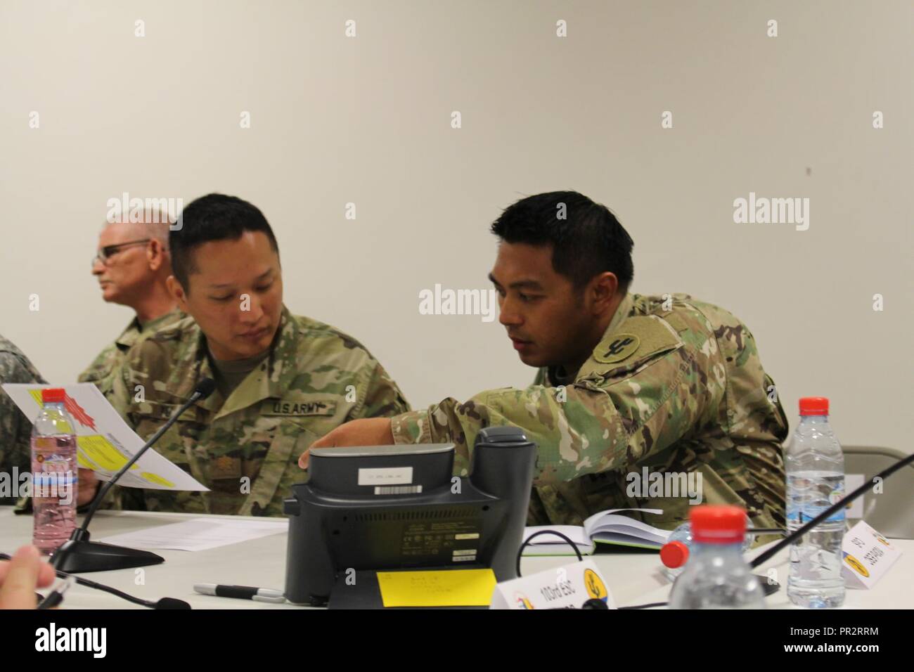 Maj. Shun Yu (left) receives information from Capt. Jason Tindungen ...