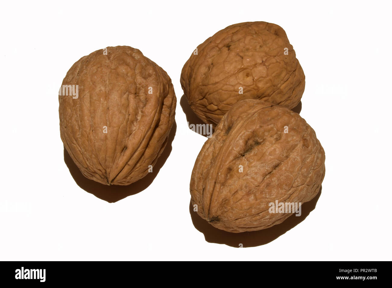View of three walnuts on white background hi-res stock photography and ...