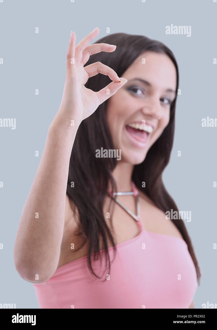 Young model showing OK sign in studio over white background Stock Photo ...
