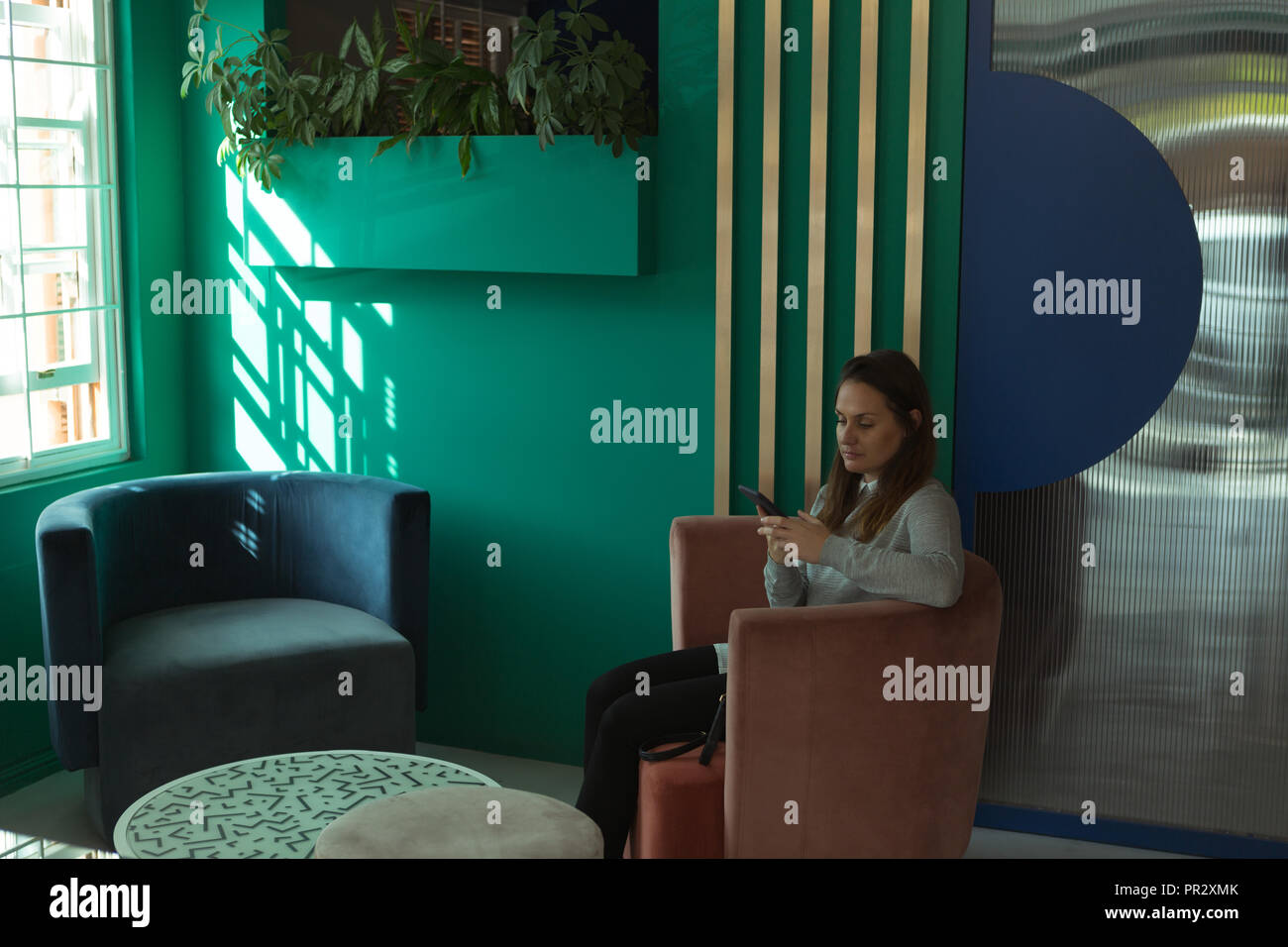 Female customer using mobile phone in boutique shop Stock Photo - Alamy