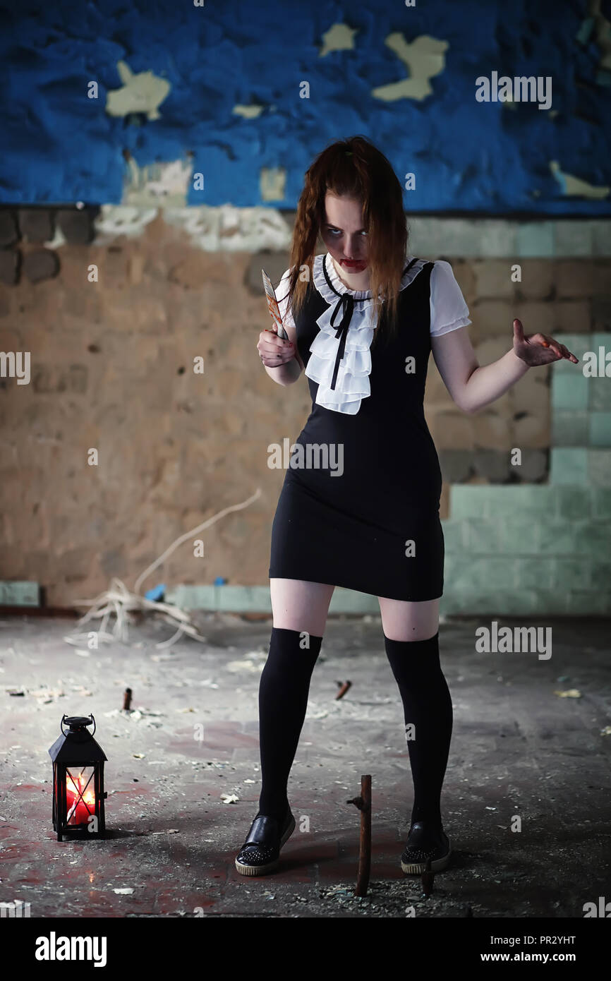 A young girl in the blood and with a knife Stock Photo - Alamy