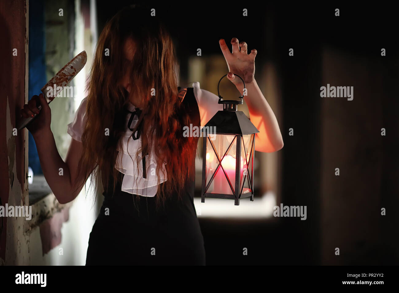 A young girl in the blood and with a knife Stock Photo - Alamy