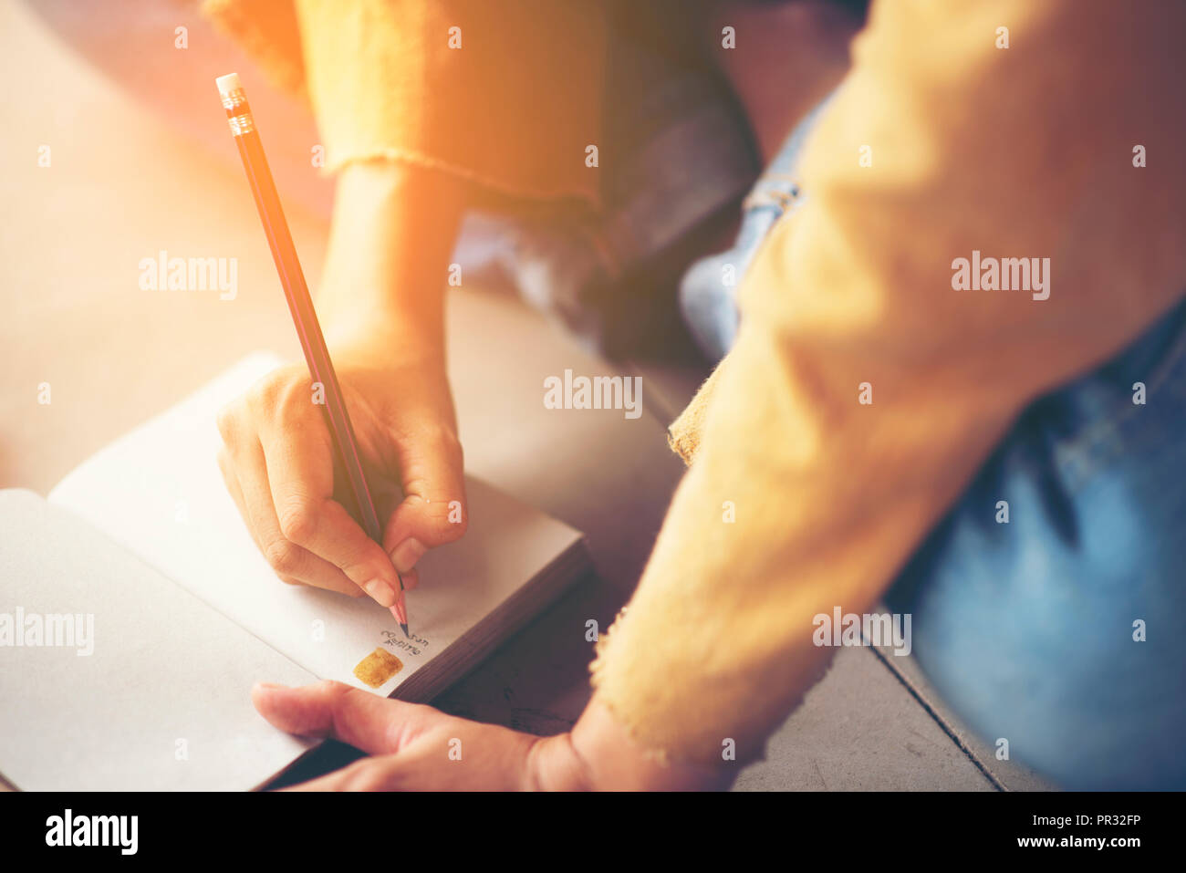 artist hands drawing on a book Stock Photo - Alamy