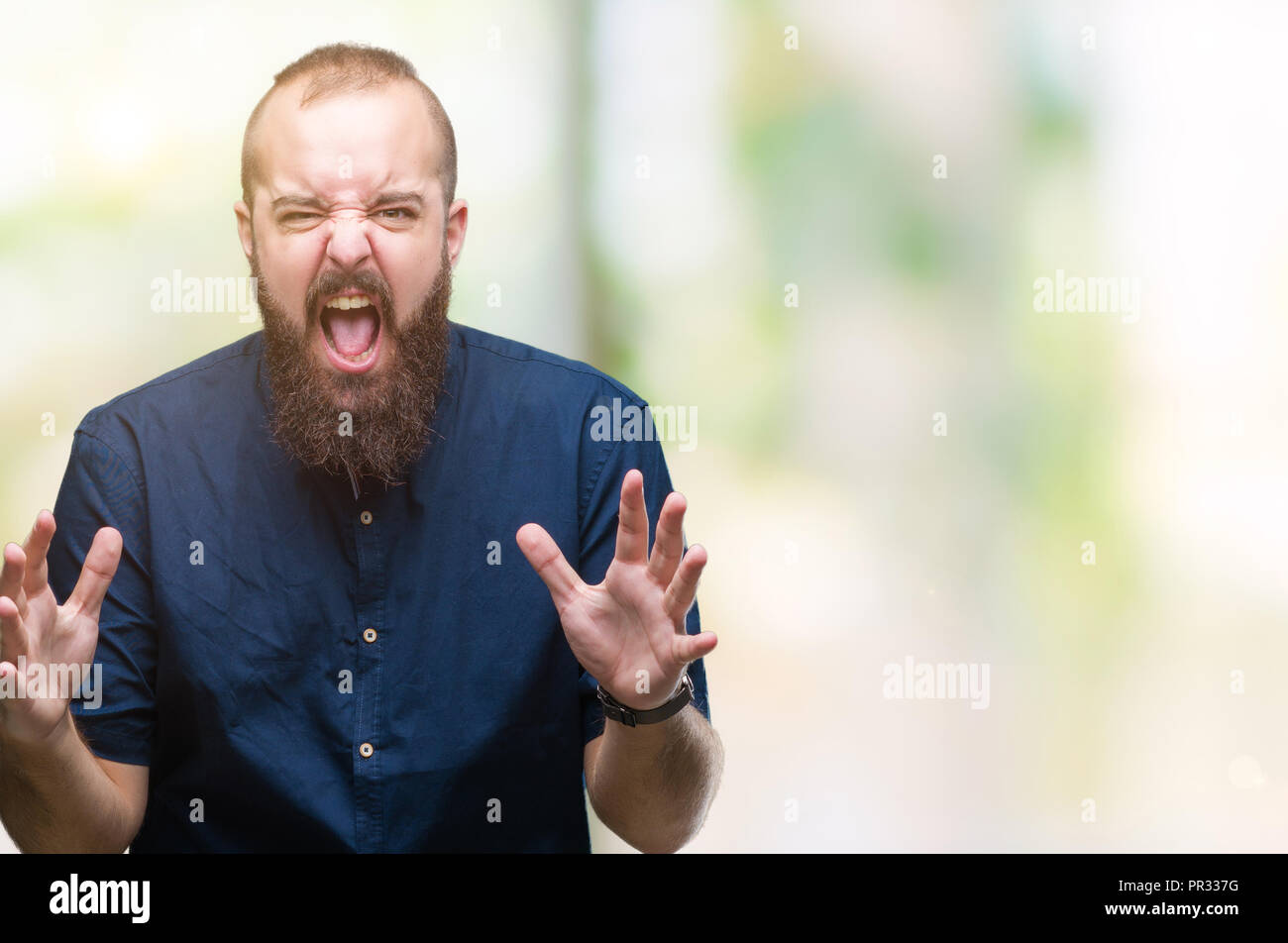 Young caucasian hipster man over isolated background crazy and mad ...