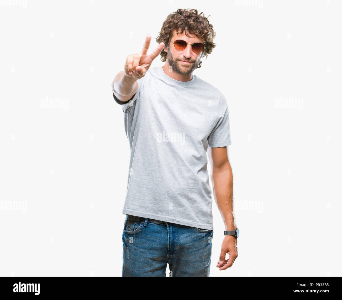 Handsome hispanic model man wearing sunglasses over isolated background ...