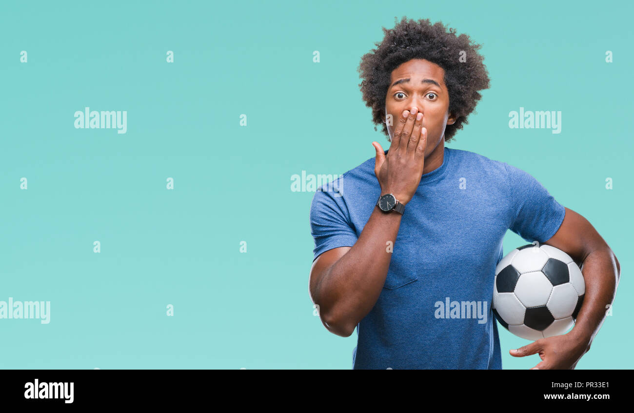Afro american man holding football ball over isolated background cover ...