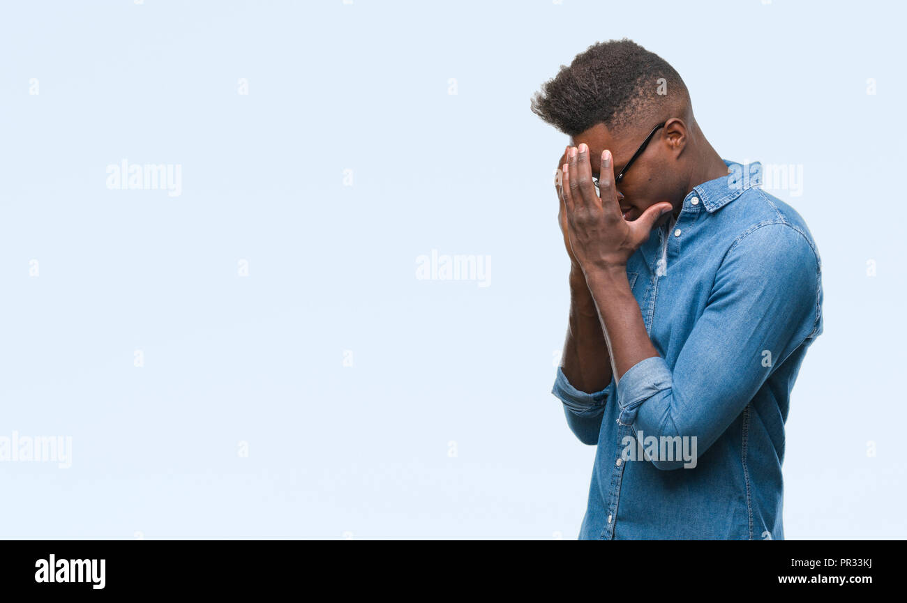 Young african american man over isolated background with sad expression ...