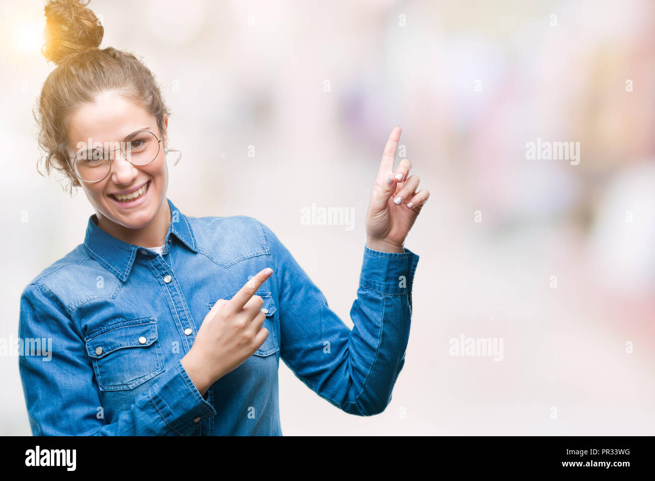 Beautiful young brunette curly hair girl wearing glasses over isolated ...