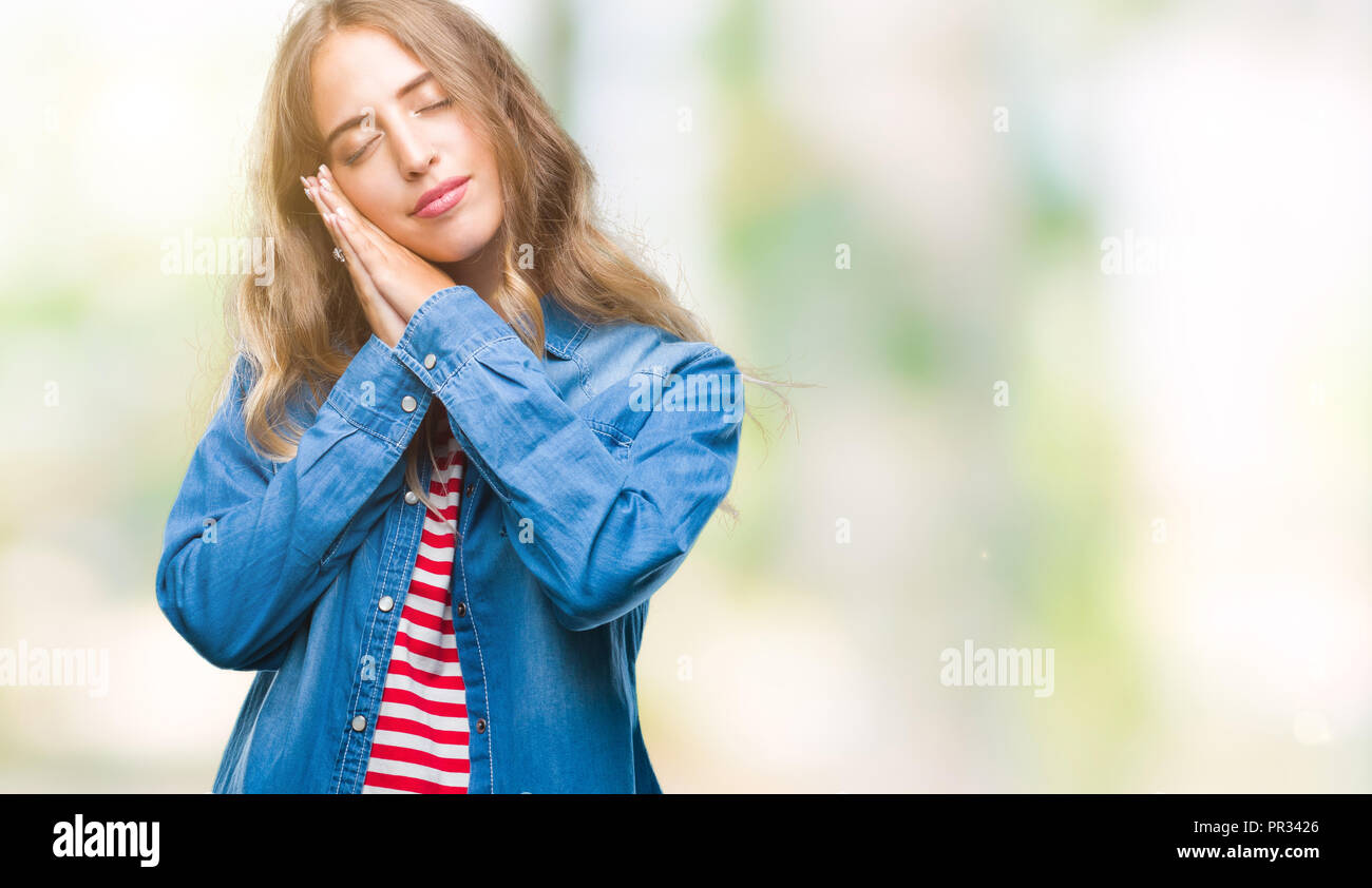 Beautiful young blonde woman over isolated background sleeping tired ...