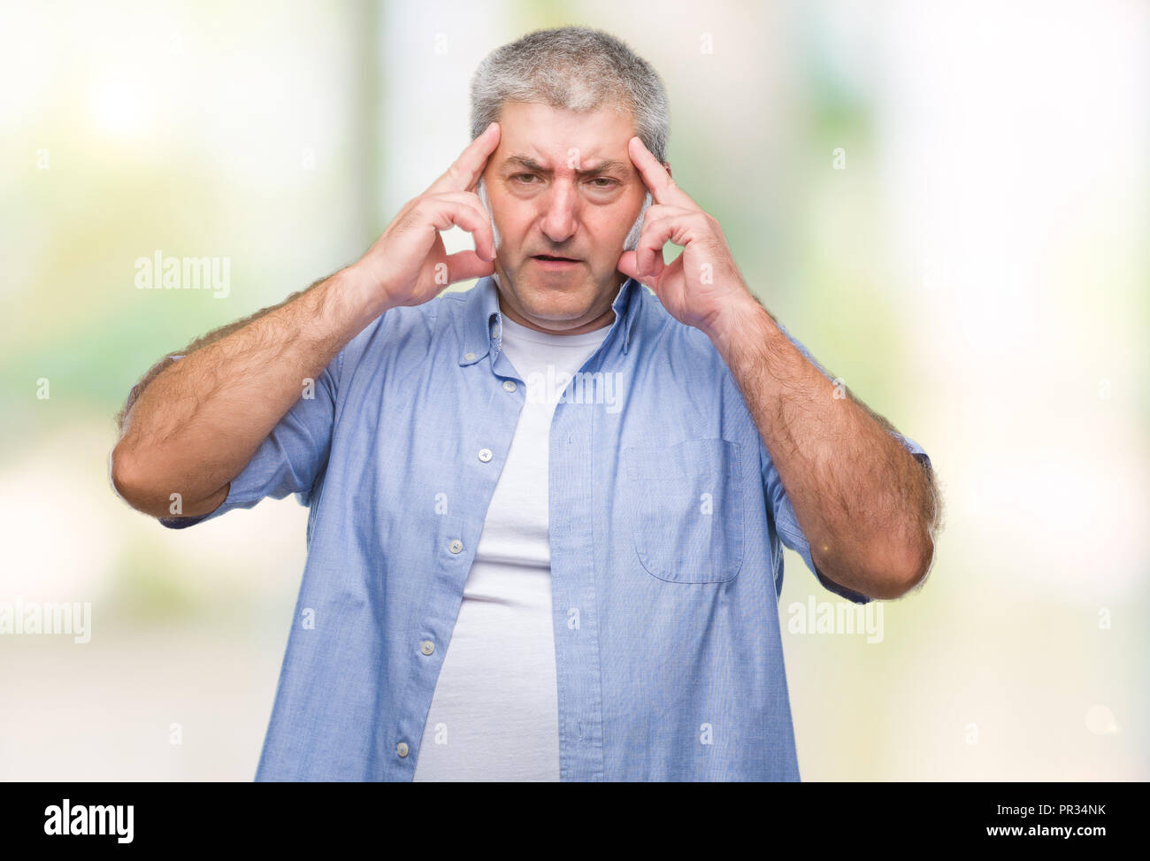 Handsome senior man over isolated background with hand on head for pain ...