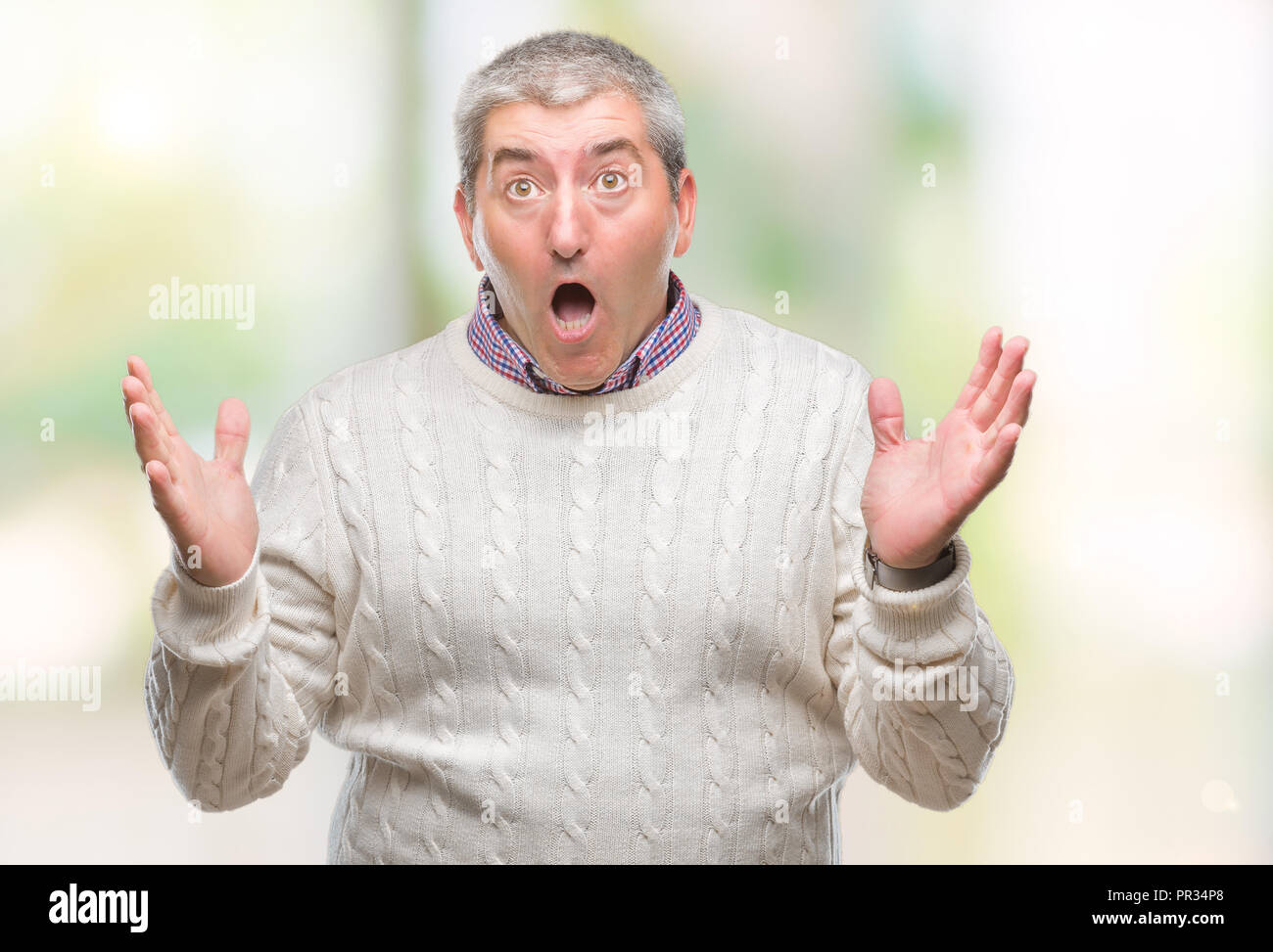 Handsome senior man wearing winter sweater over isolated background ...