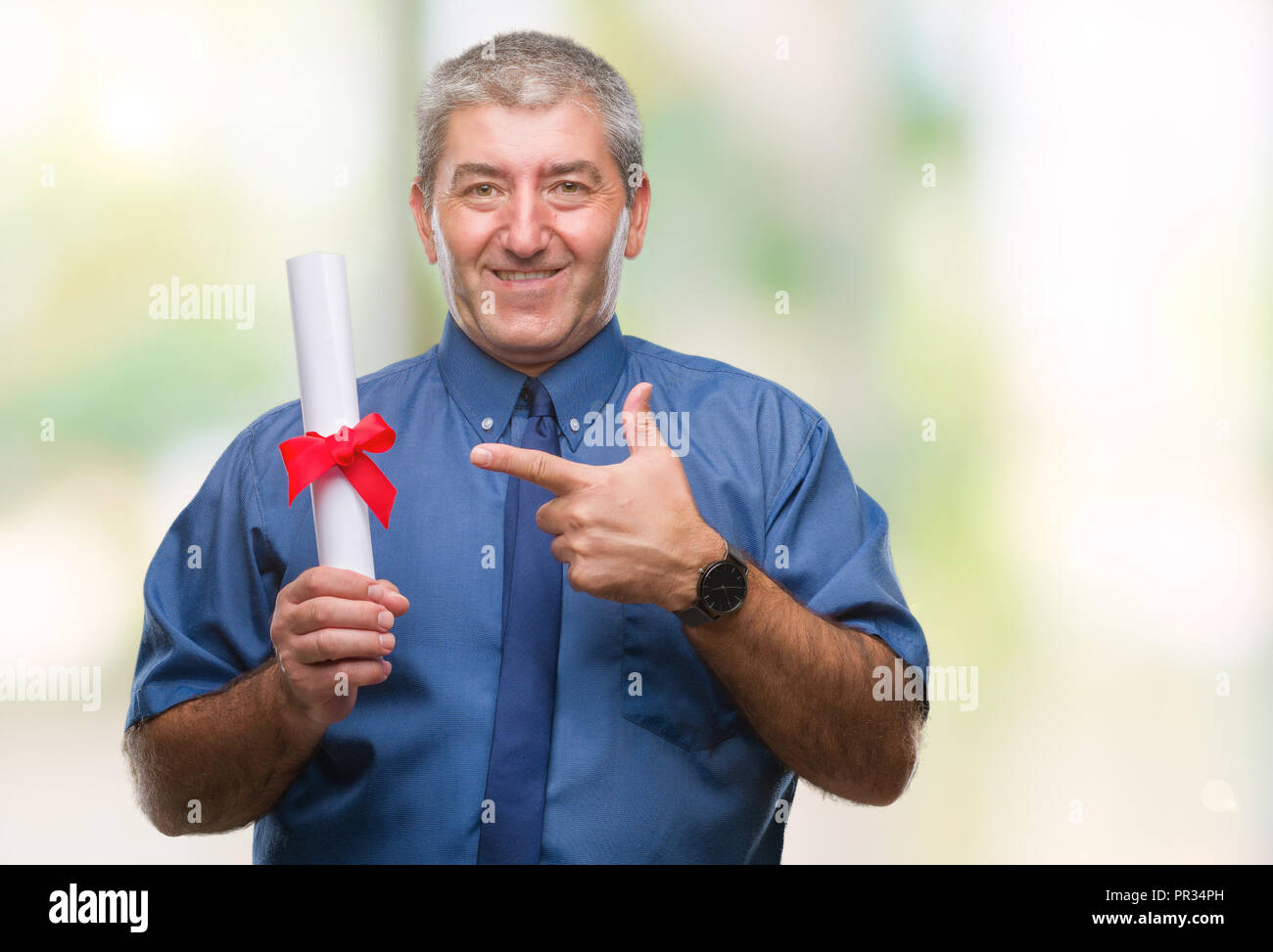 Handsome senior man holding degree over isolated background very happy ...
