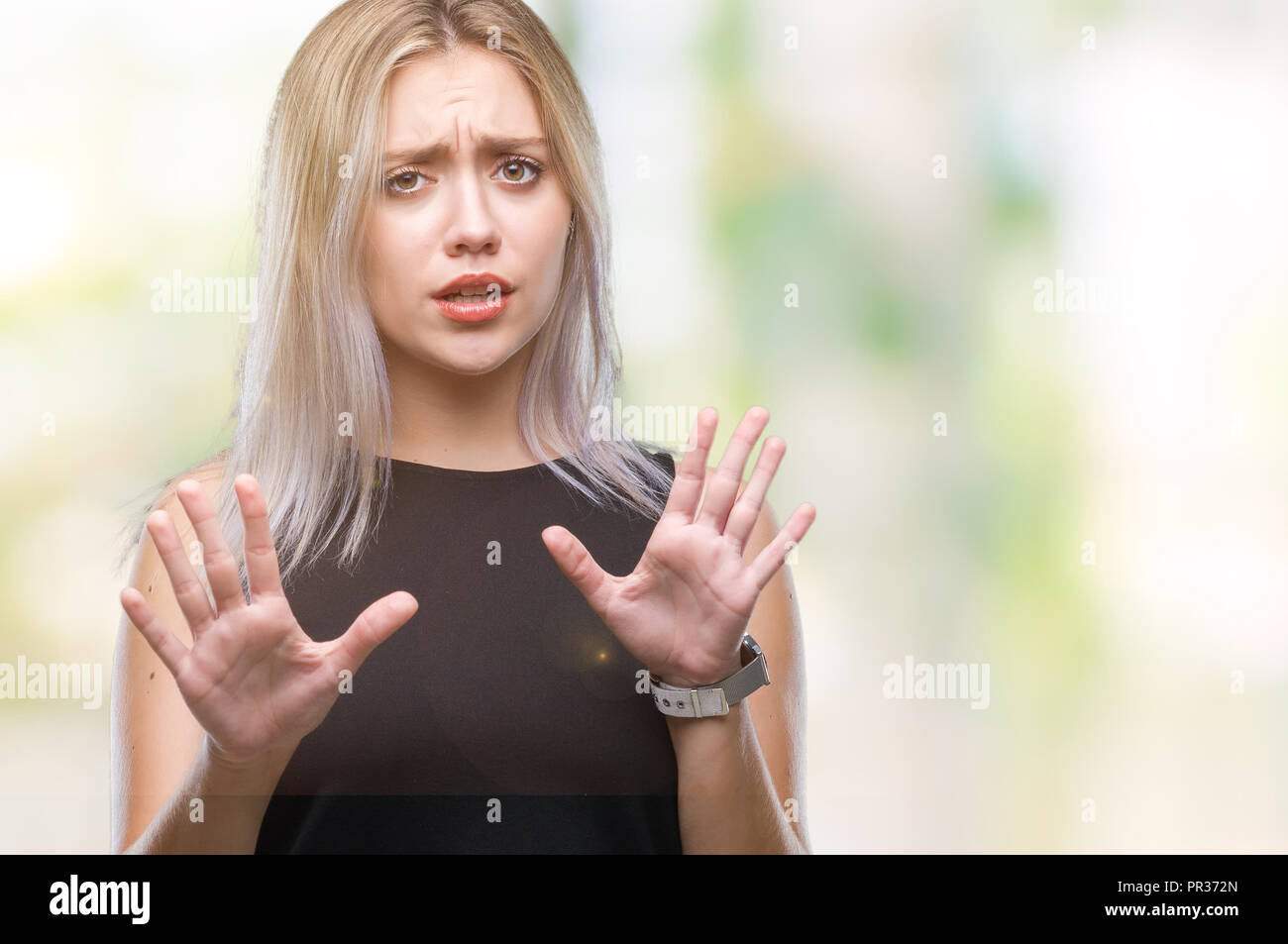 Young blonde woman over isolated background afraid and terrified with ...