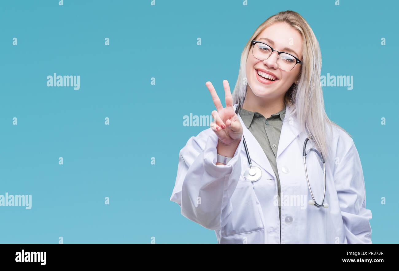 Young blonde doctor woman over isolated background with a big smile on ...