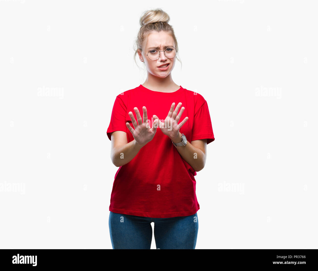 Young blonde woman wearing glasses over isolated background disgusted ...