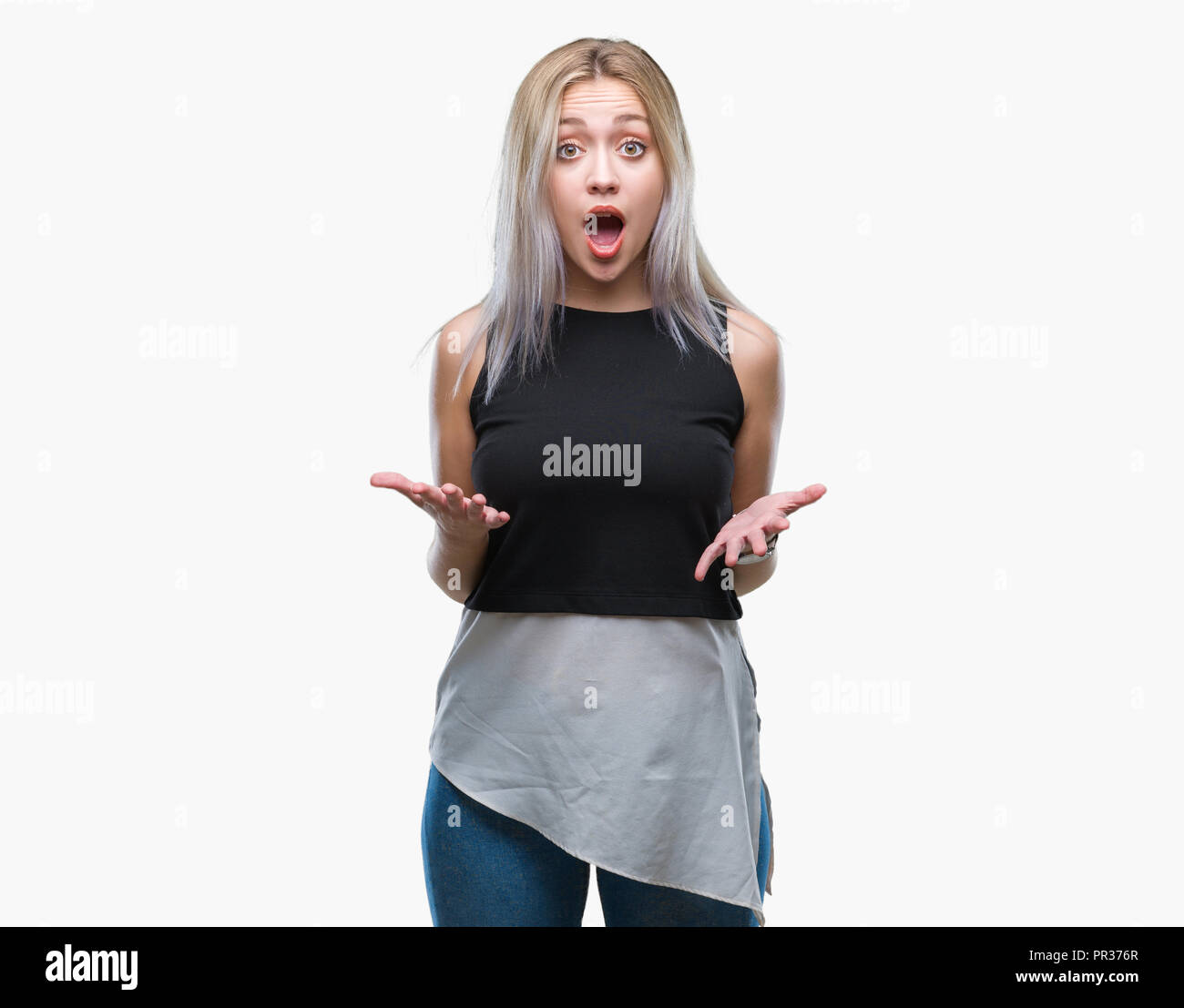 Young blonde woman over isolated background afraid and shocked with ...