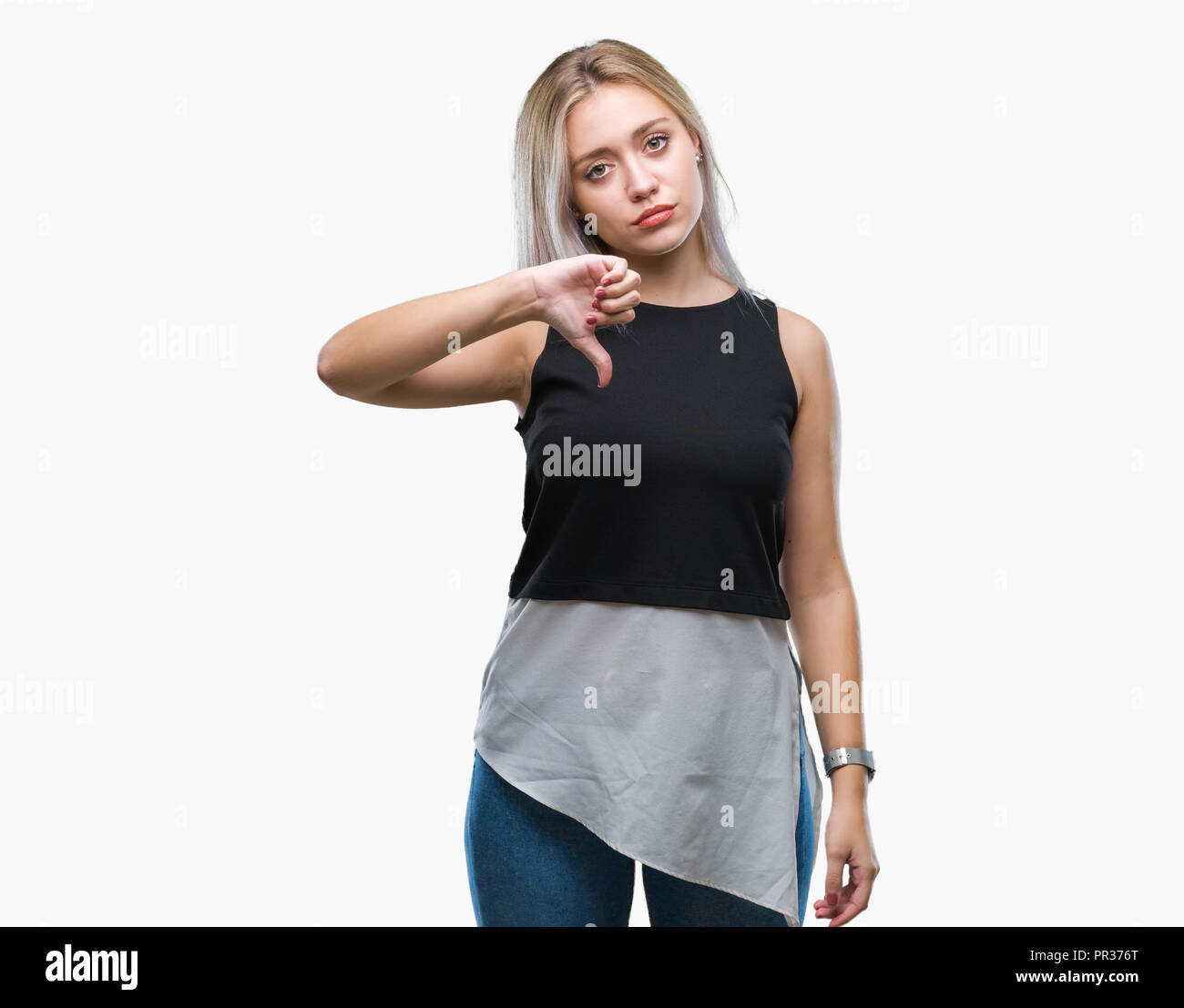 Young blonde woman over isolated background looking unhappy and angry ...