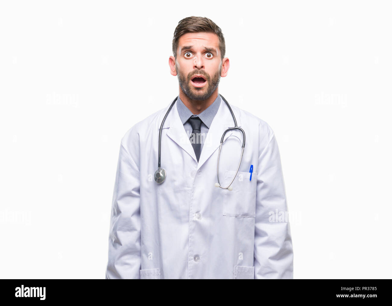 Young handsome doctor man over isolated background afraid and shocked ...