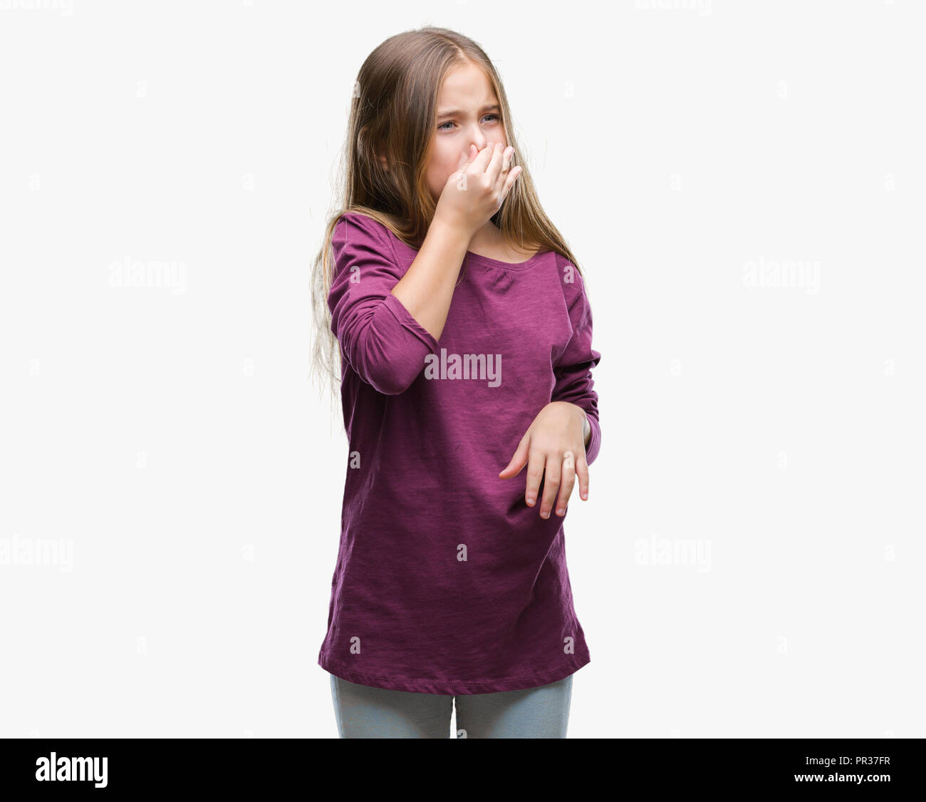 Young beautiful girl over isolated background smelling something stinky ...