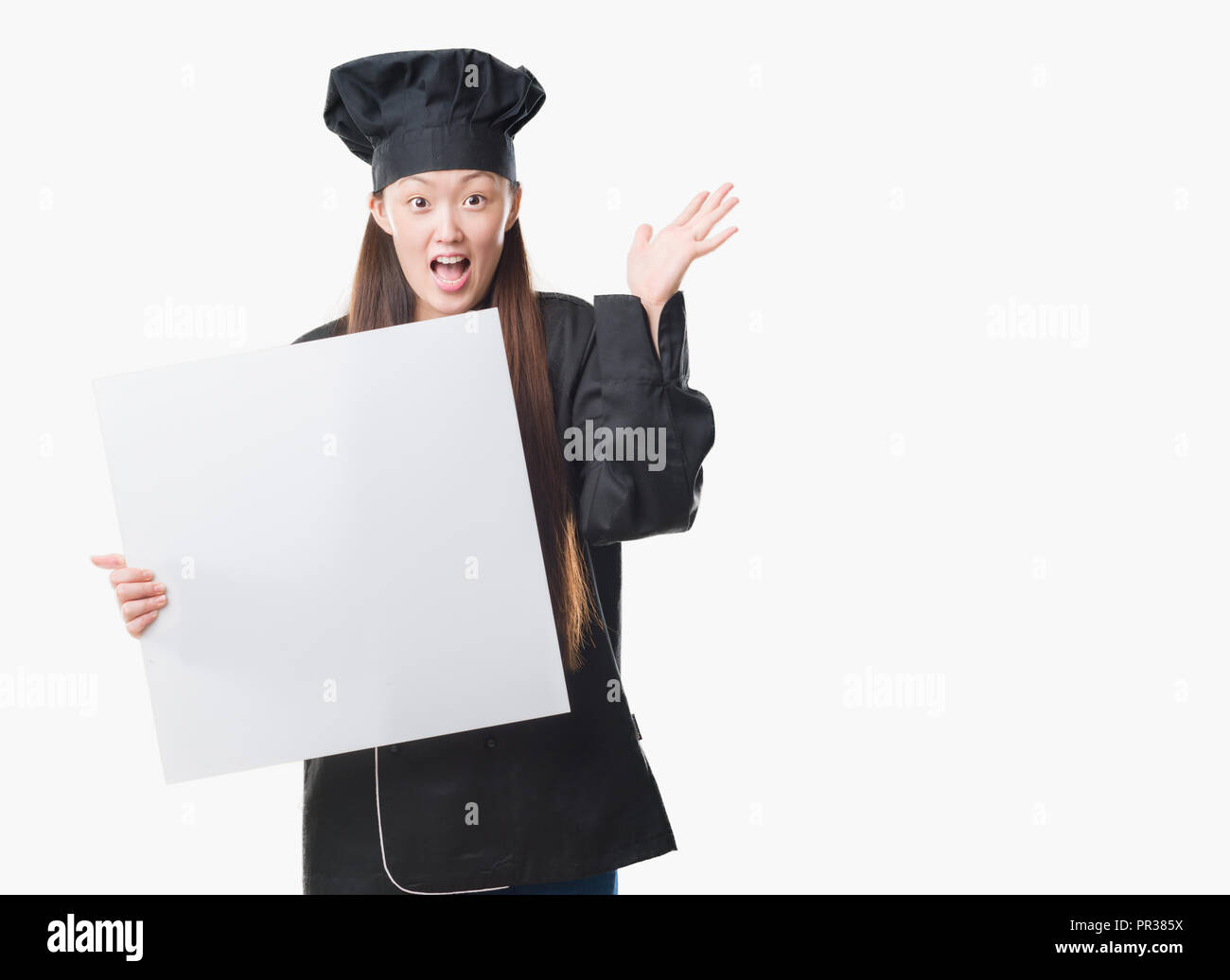 Young Chinese woman over isolated background wearing chef uniform ...