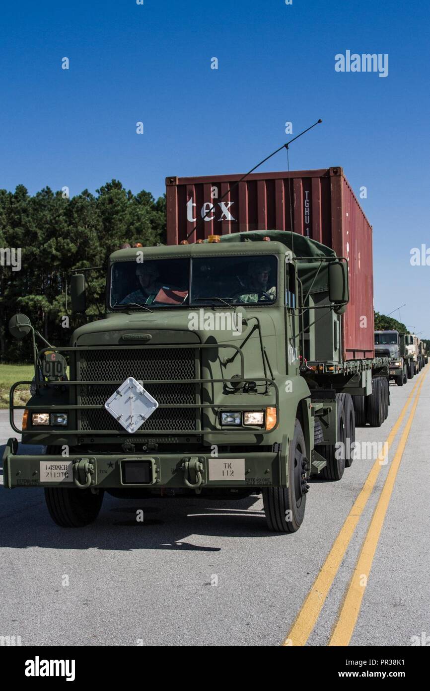 M-878 trucks are staged to be loaded with freight containers that will ...