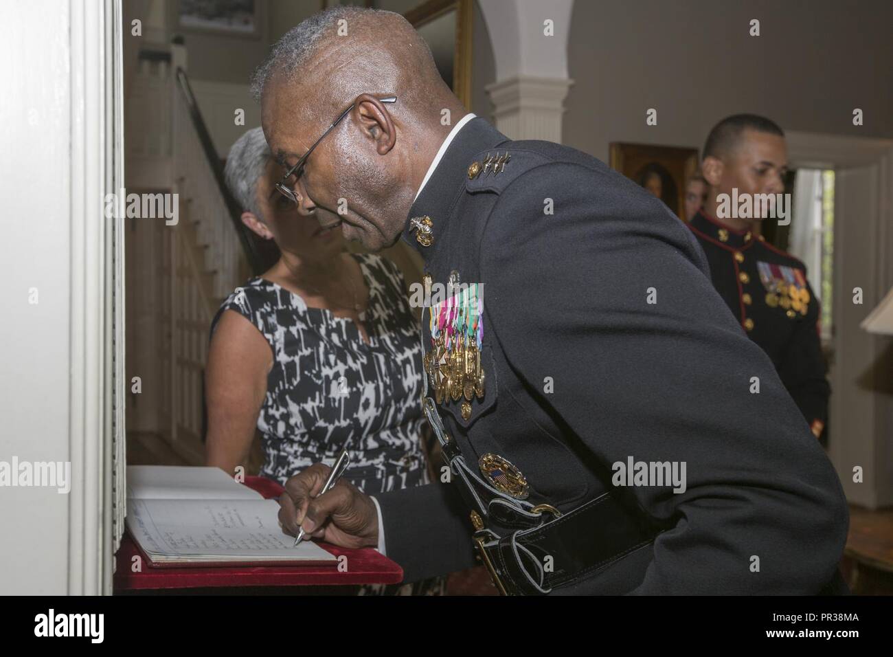 U.S. Marine Corps Lt. Gen. Ronald L. Bailey signs a guest book before ...