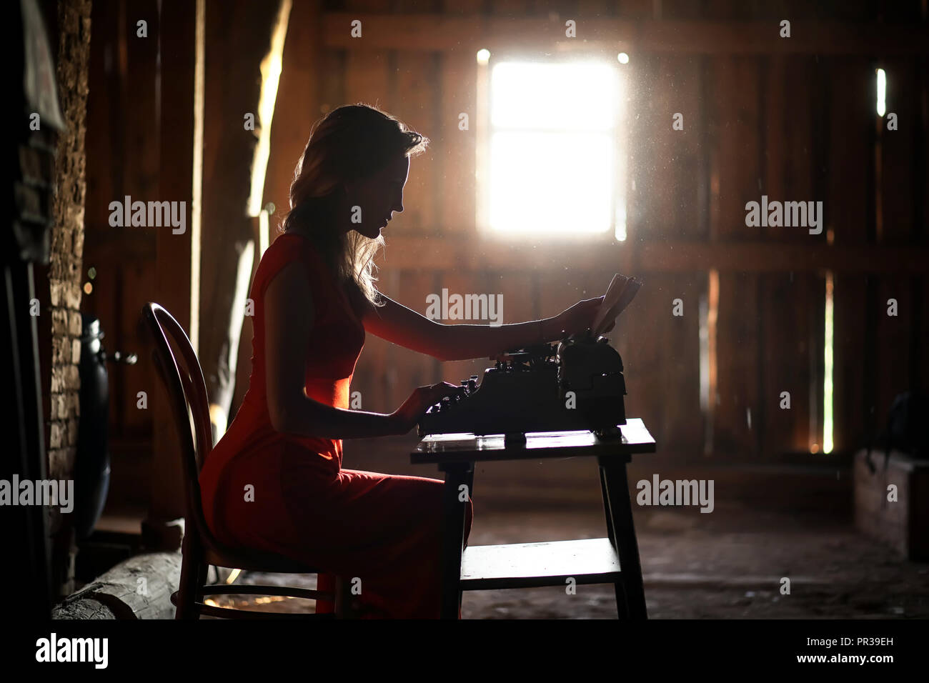A girl in retro style prints on an old typewriter Stock Photo - Alamy