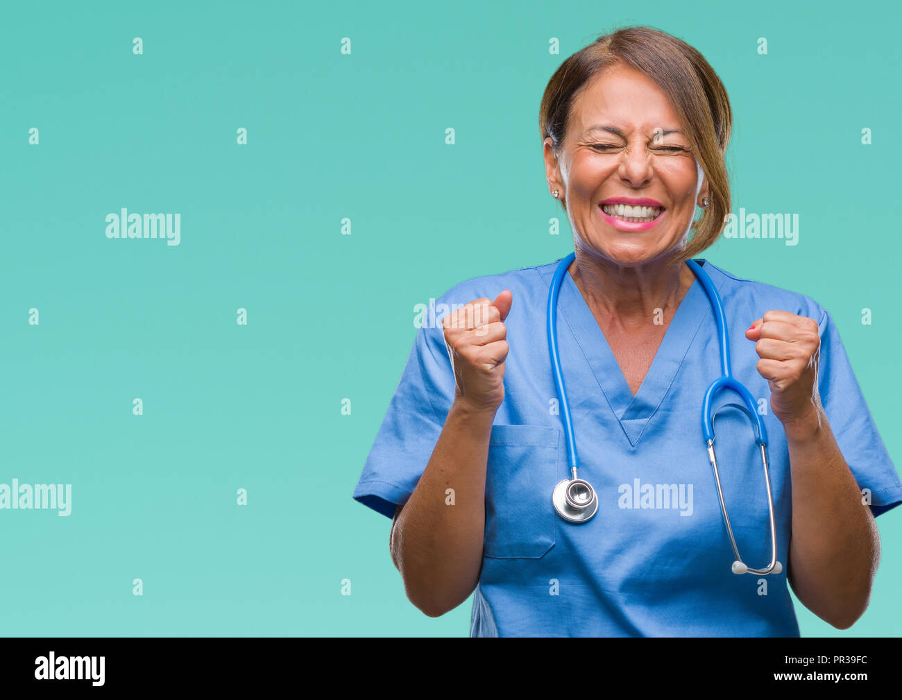 Middle age senior nurse doctor woman over isolated background excited ...