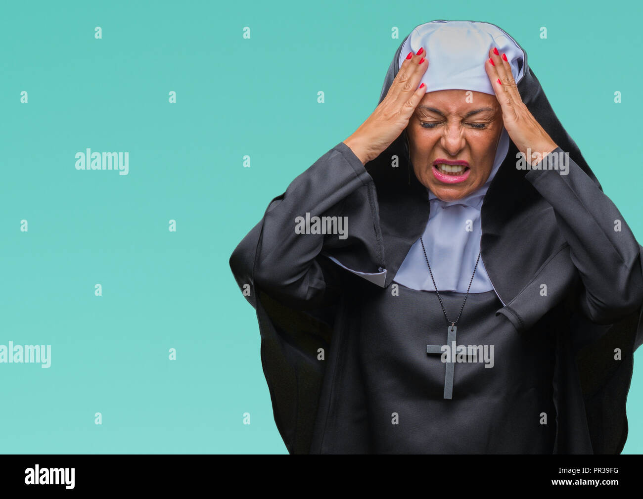 Middle age senior christian catholic nun woman over isolated background ...